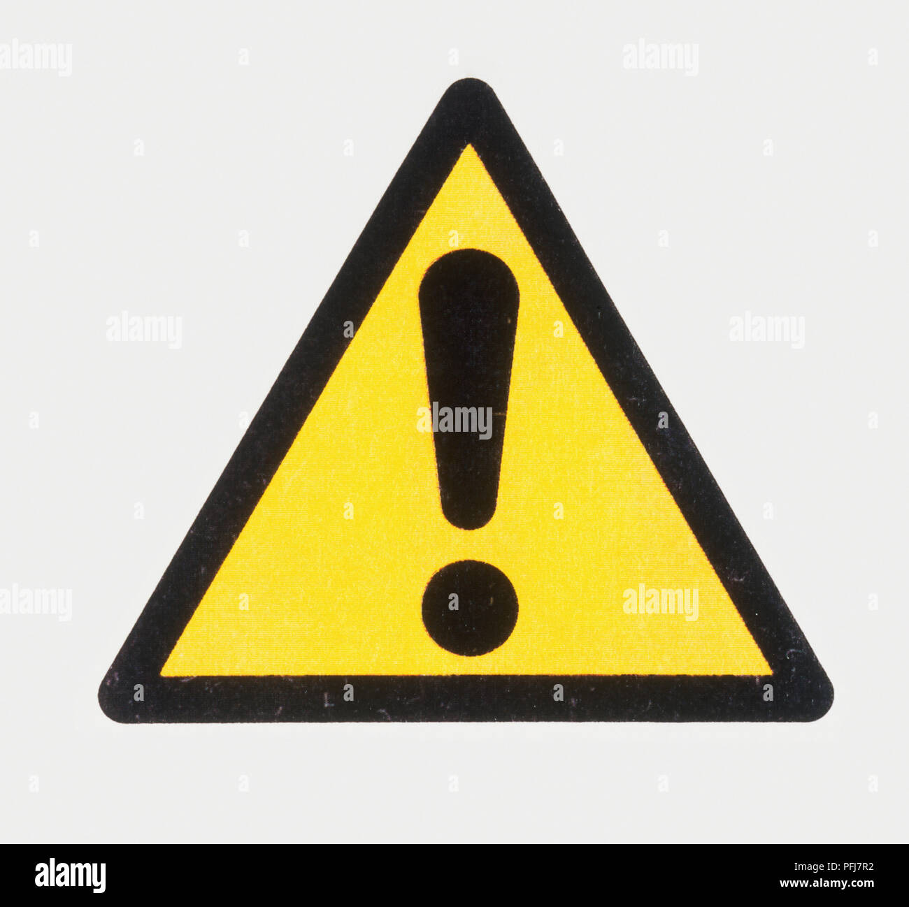 An exclamation mark on a yellow triangular sign Stock Photo - Alamy