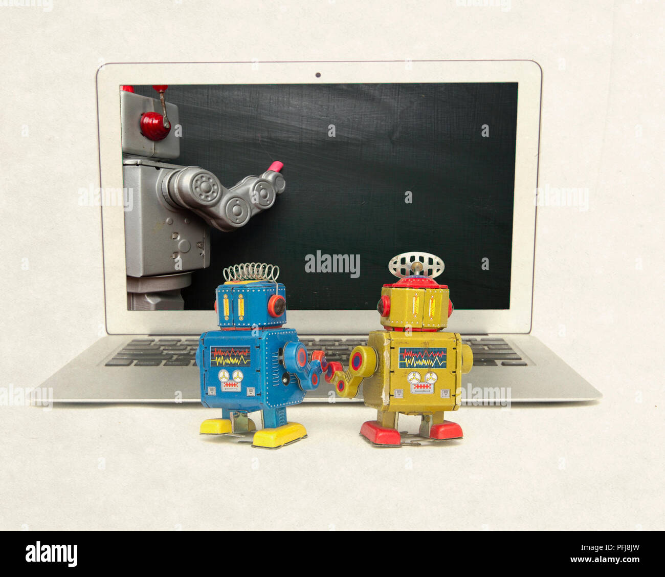 two retro bobots learning stuff at a laptop computer isolated Stock ...