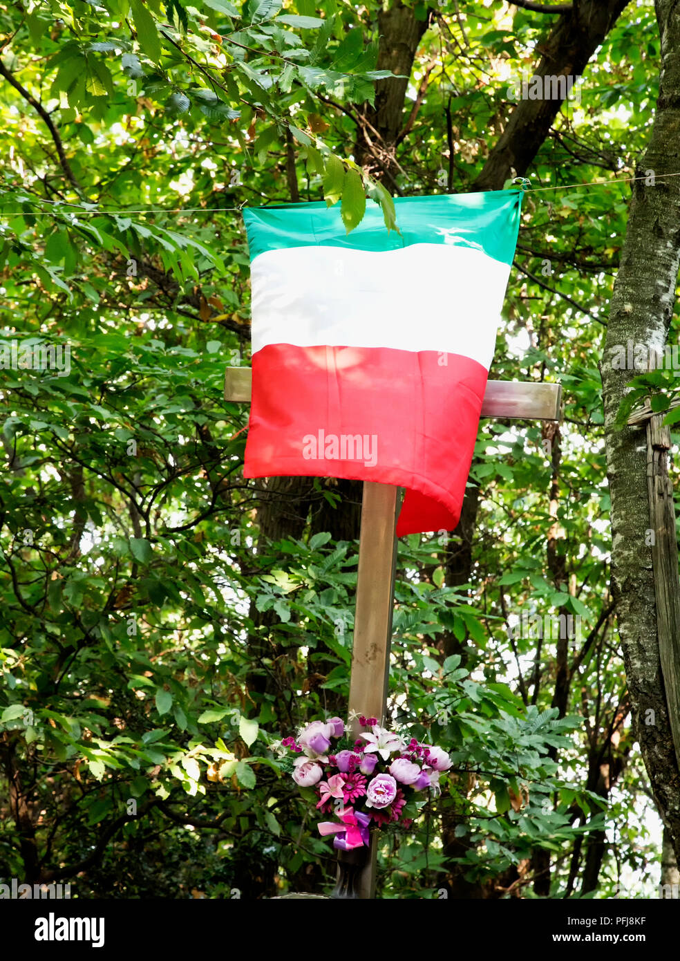 Italian flag over cross with flowers in the woods, vertical image Stock ...