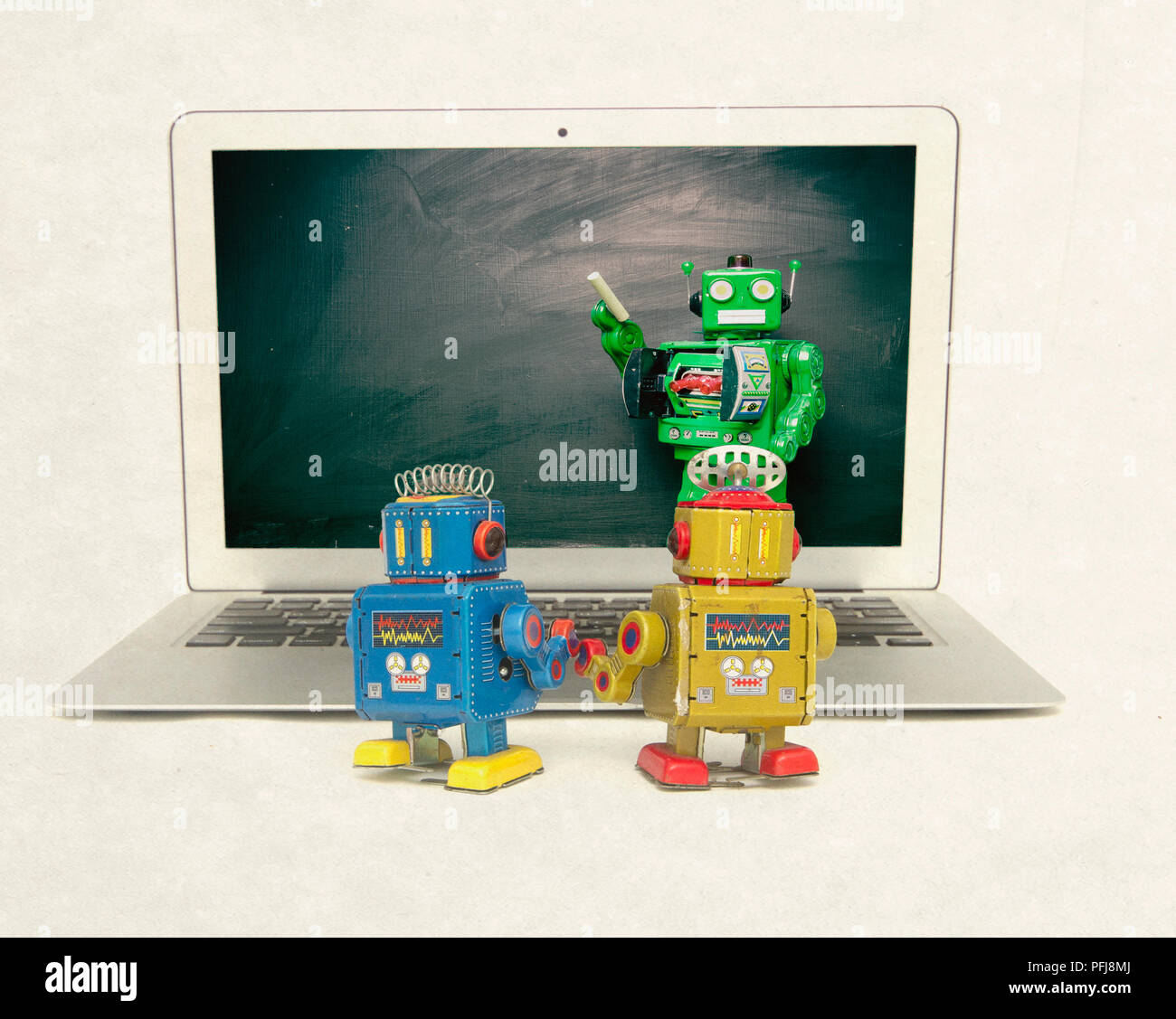 two retro bobots learning stuff at a laptop computer isolated Stock ...