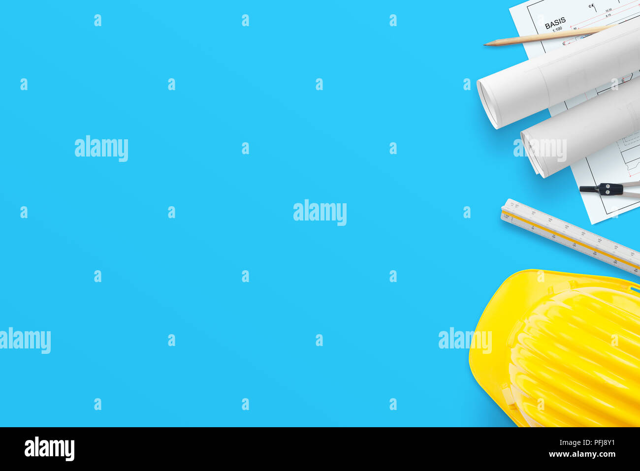 Architect workdesk with project papers, tools and yellow helmet. Blue ...