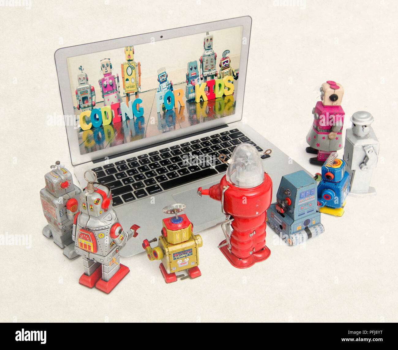retro robots learn coding from a laptop isolated Stock Photo - Alamy