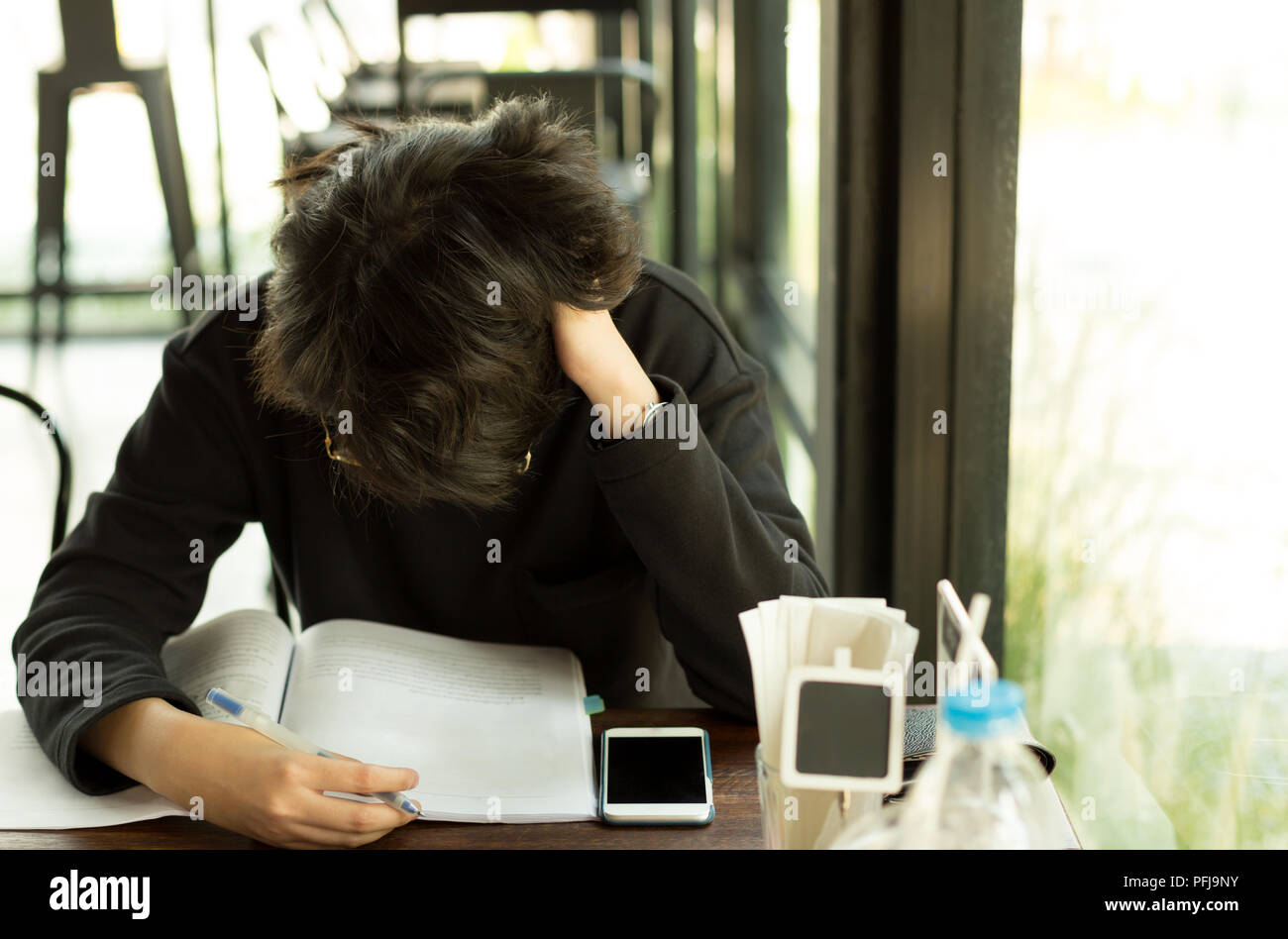 Stressed student reading book hi-res stock photography and images - Alamy