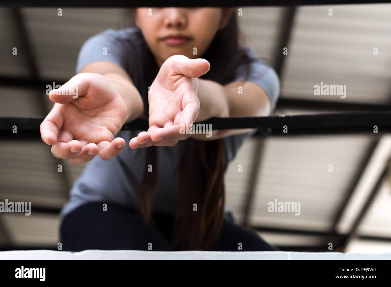 Young woman victim hand reach out for help from a metal bars Stock ...
