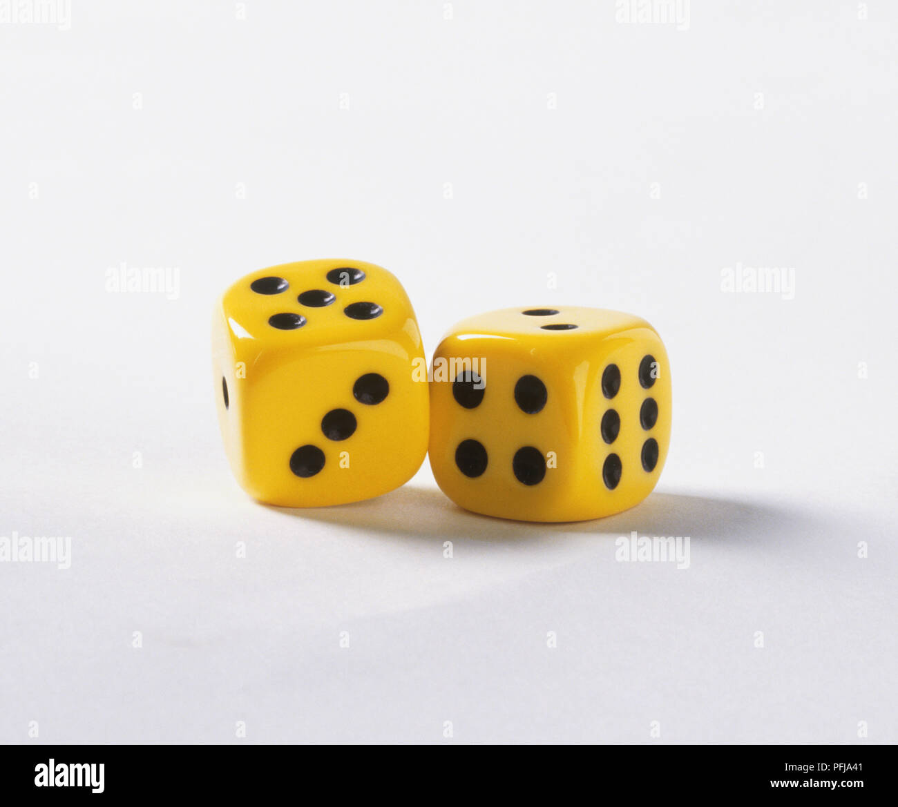 Two yellow dice Stock Photo - Alamy