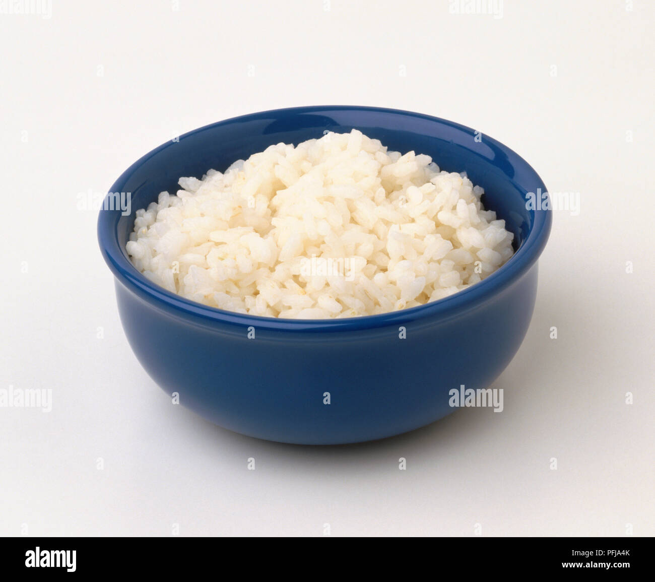 Plain white rice in blue bowl Stock Photo - Alamy