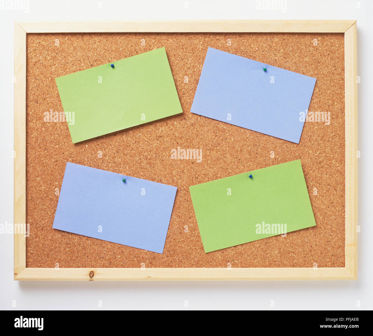 Blank pieces of coloured paper pinned to pin board Stock Photo - Alamy