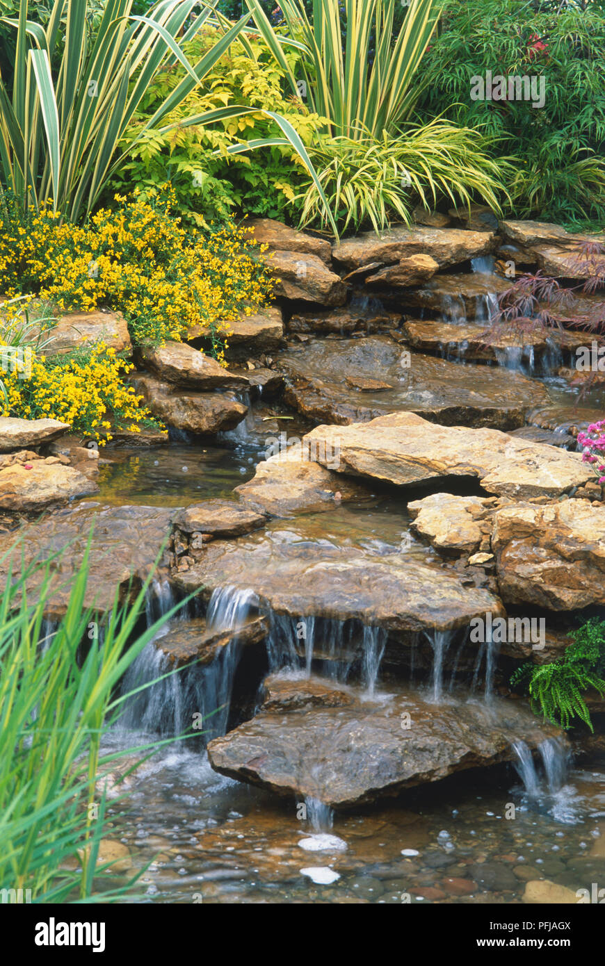 Water garden, water cascading down rocks Stock Photo - Alamy