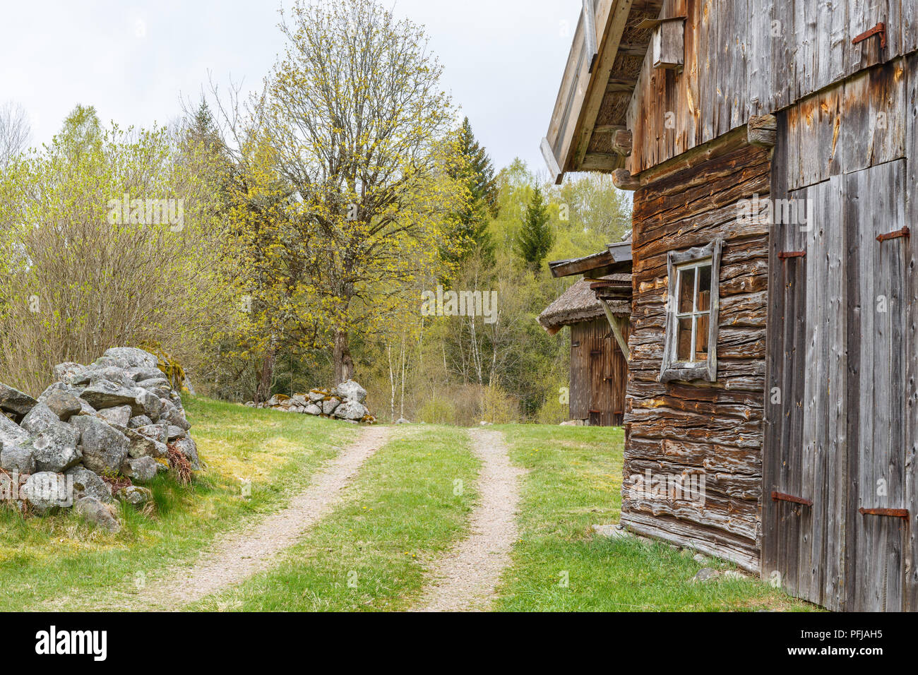 Farm road by an old barn Stock Photo - Alamy