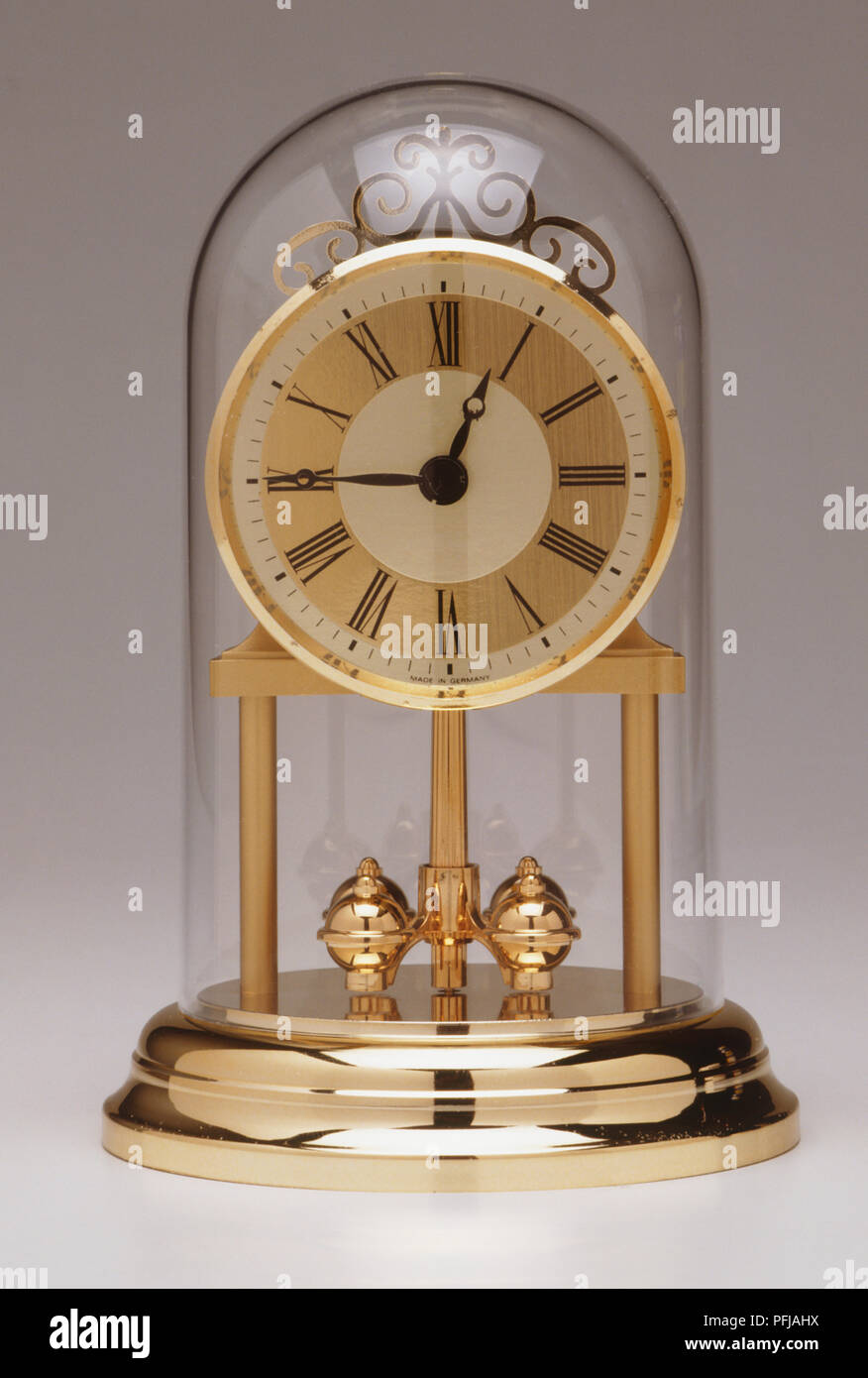 Clock in a glass case Stock Photo - Alamy