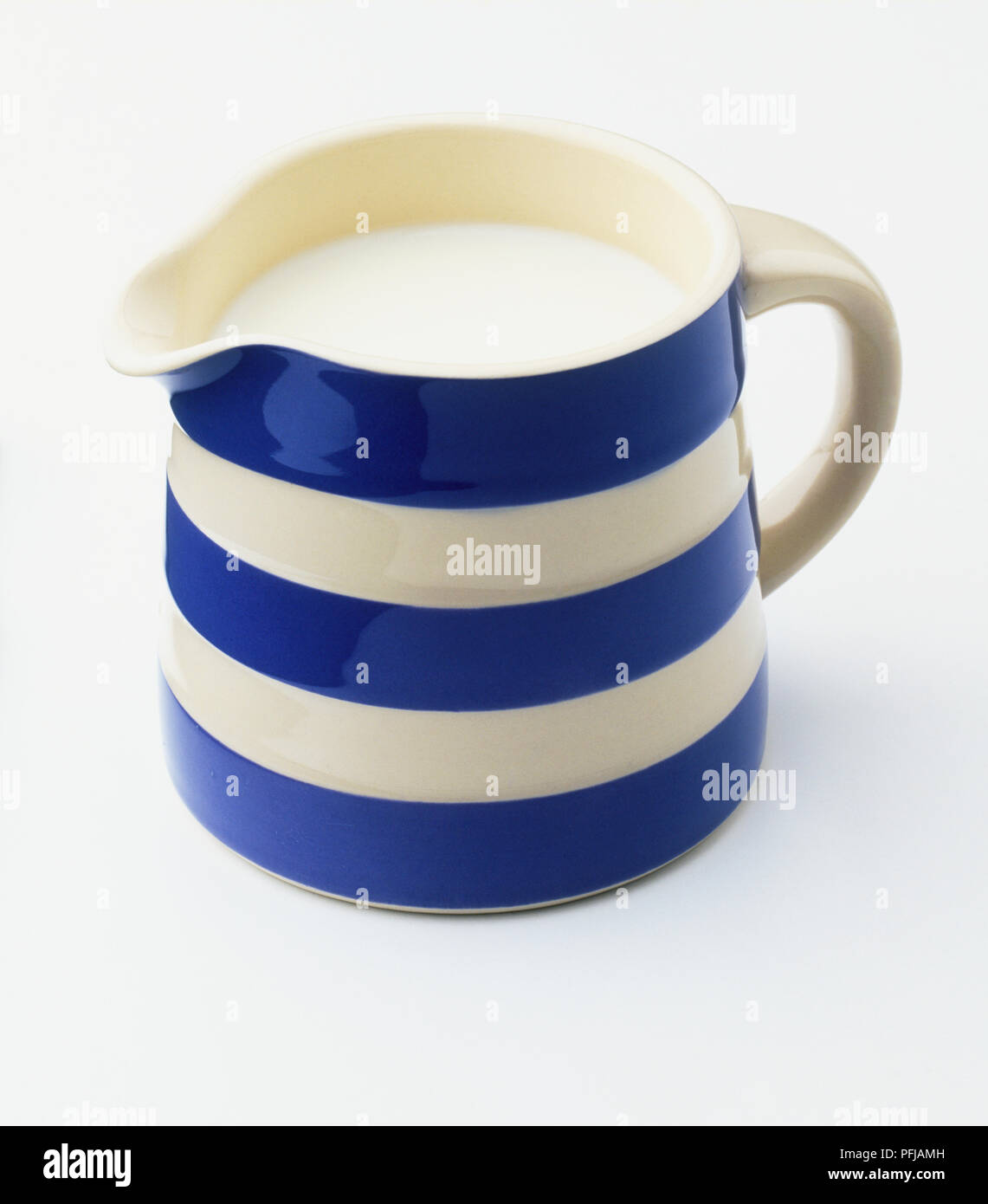 Milk in blue and white striped jug Stock Photo - Alamy