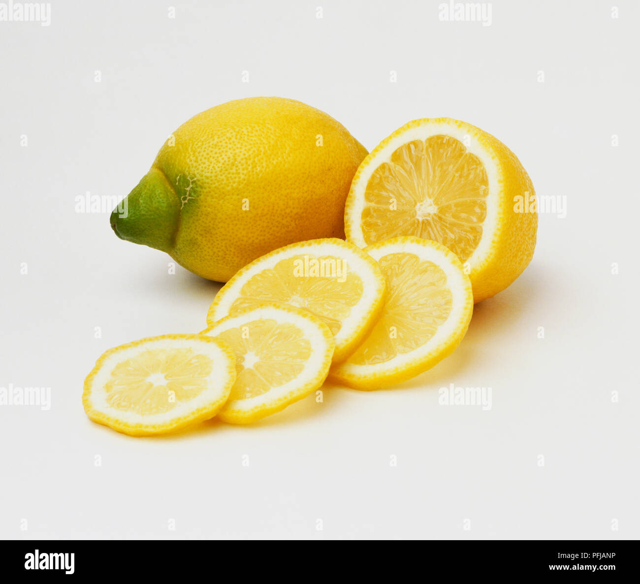 A whole lemon and slices cut from a second lemon Stock Photo - Alamy