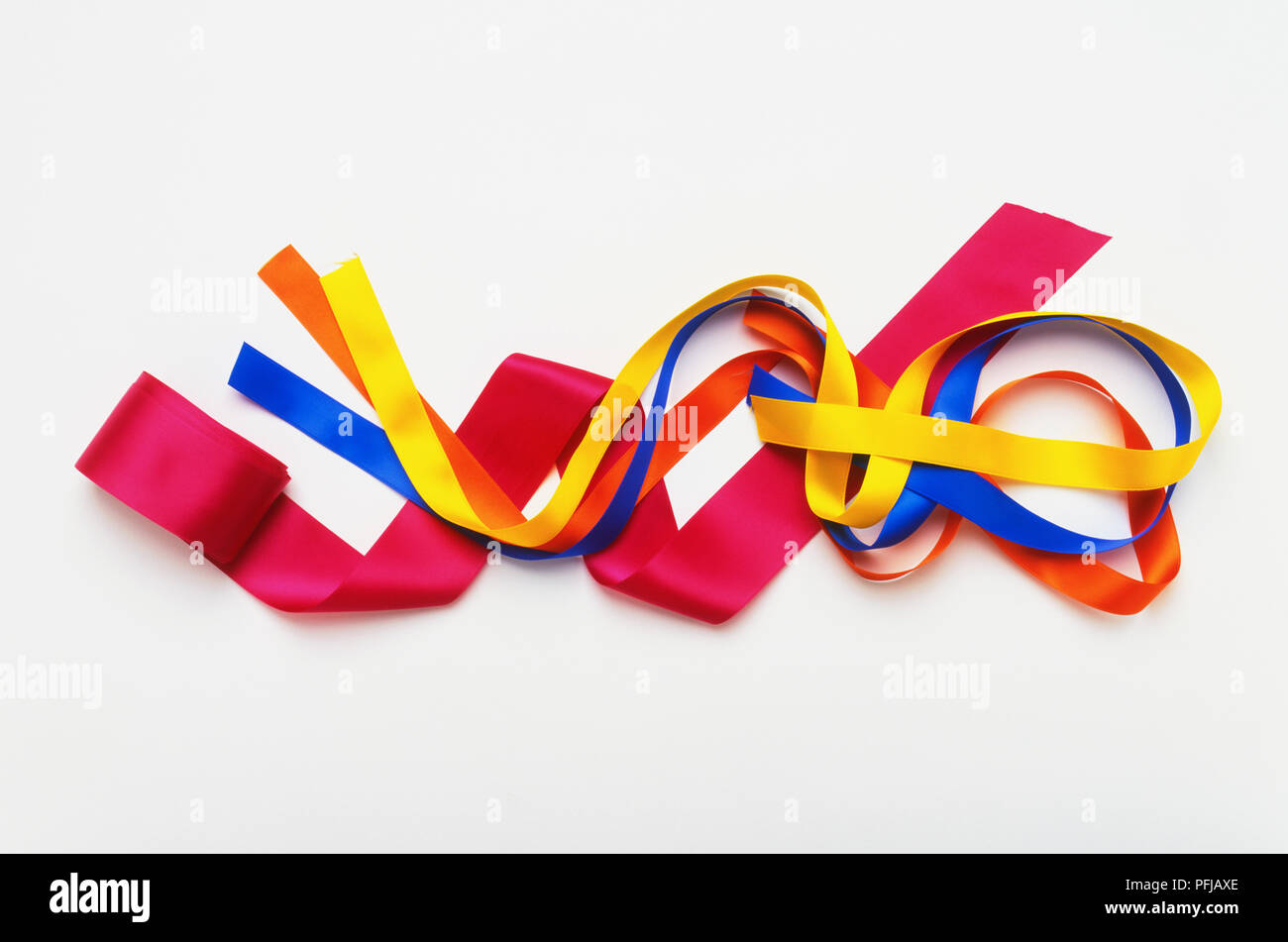 Entangled ribbons, red, yellow and blue Stock Photo - Alamy