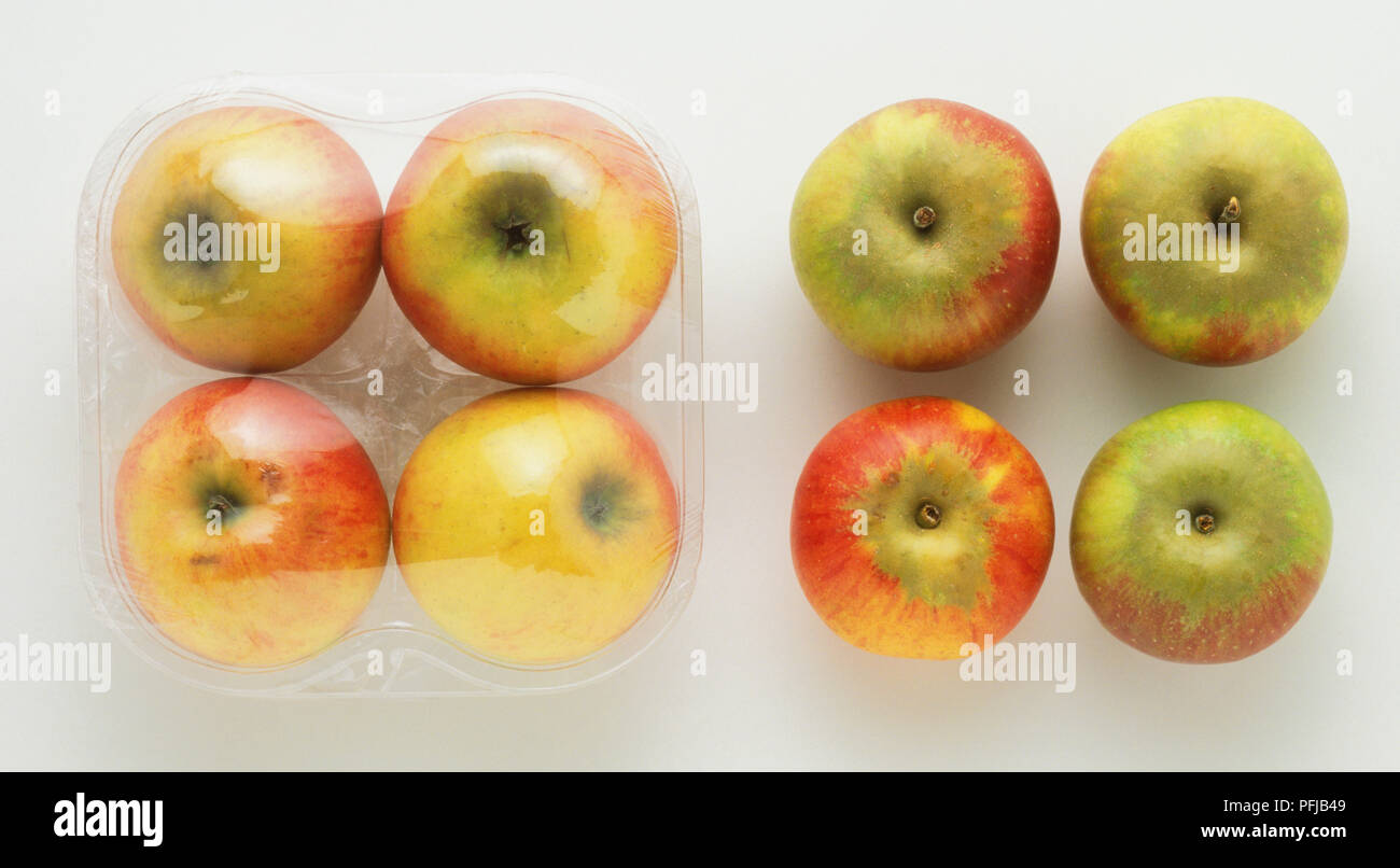 Four apples, in and out of plastic box Stock Photo - Alamy