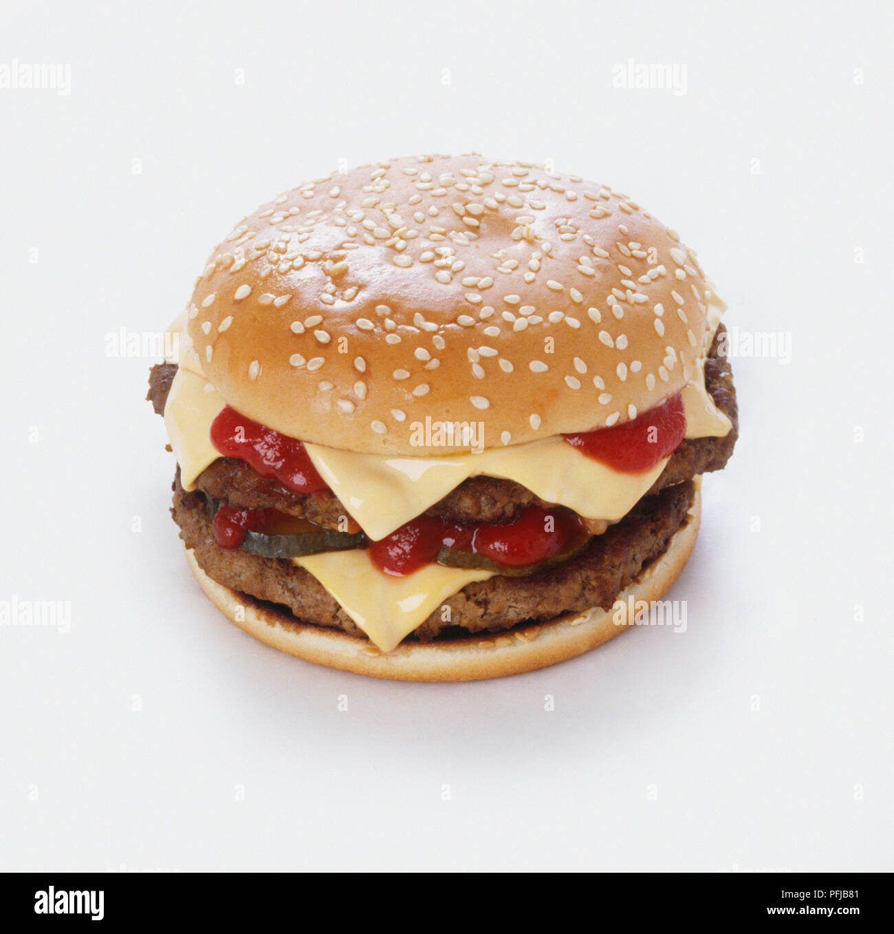 A double cheeseburger in a sesame seed bun Stock Photo - Alamy