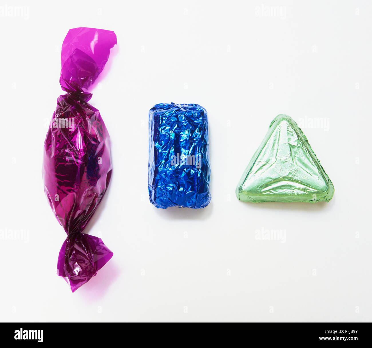 Three wrapped sweets, close up Stock Photo - Alamy