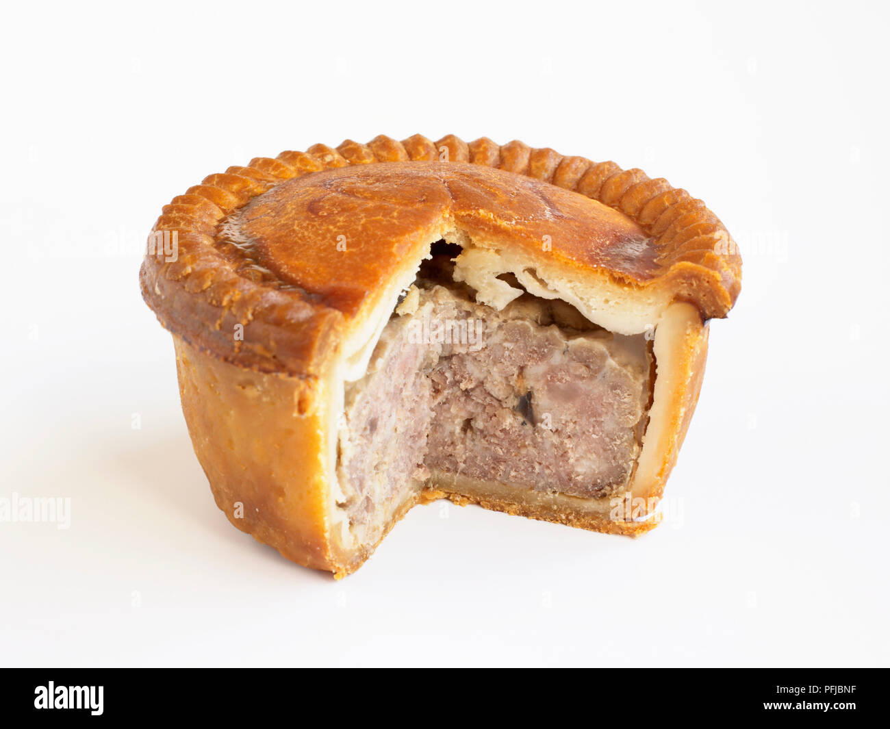 Pork pie with one slice cut away, close-up Stock Photo - Alamy