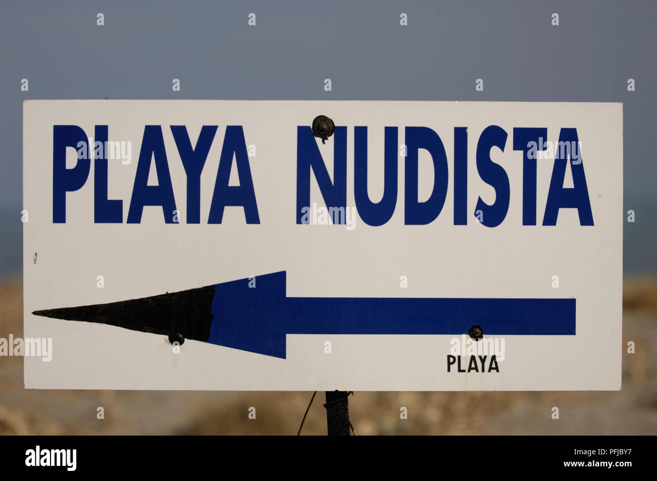 Spain, Playa Nudista, arrow sign on beach Stock Photo - Alamy