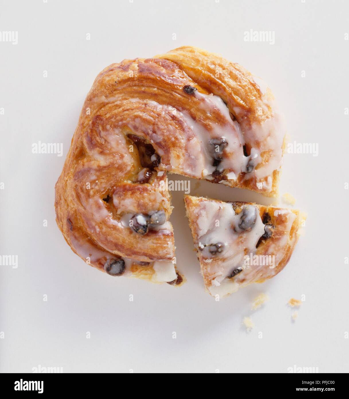 Iced danish pastry with slice removed Stock Photo - Alamy