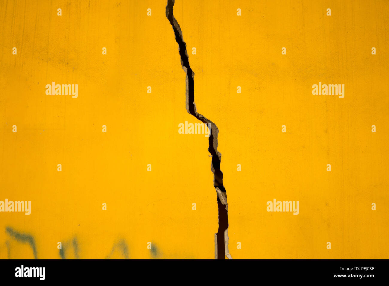 Broken yellow color concrete wall with cracked Stock Photo - Alamy