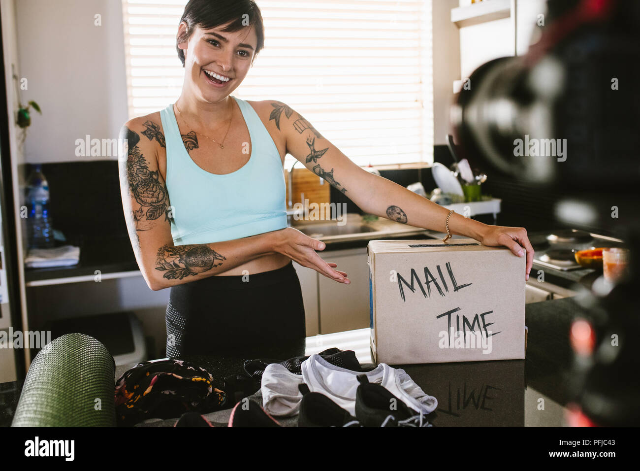 Female social media influencer standing in front of camera and showing ...