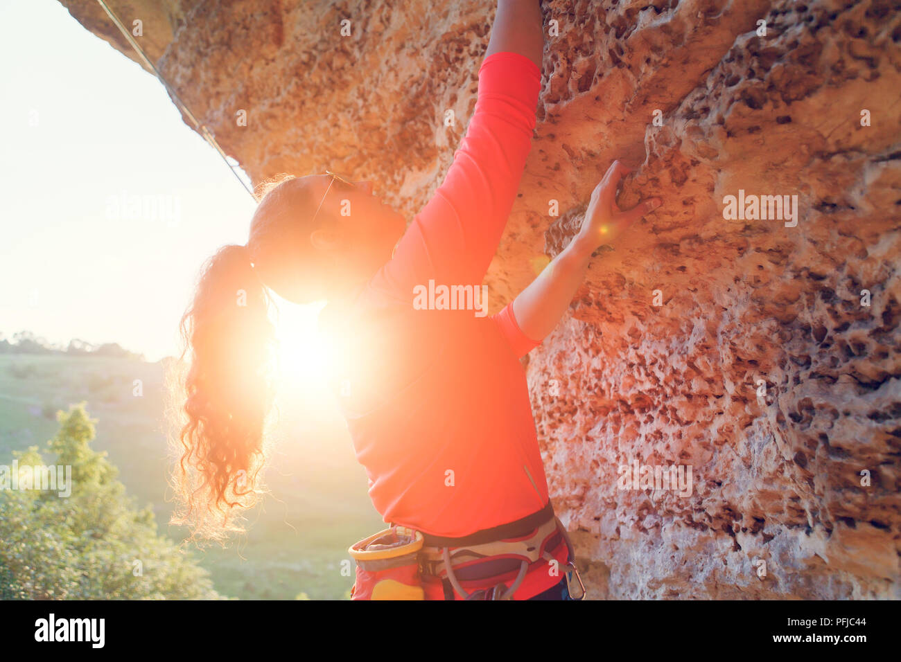 Image of young brunette tourist hiking over rock on summer day Stock ...