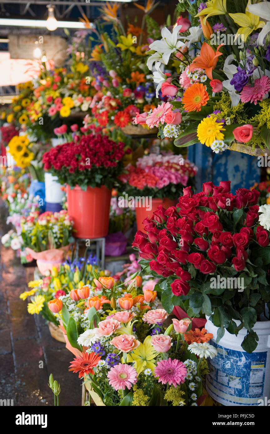 Flower stall displaying a selection of brightly coloured flowers ...