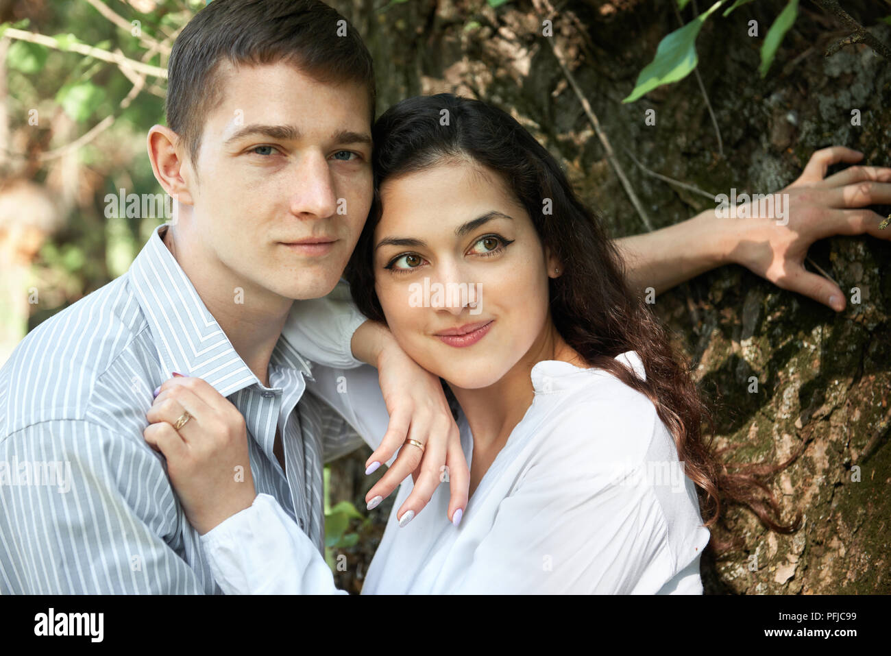 young couple walking in the forest, posing near tree, summer nature ...