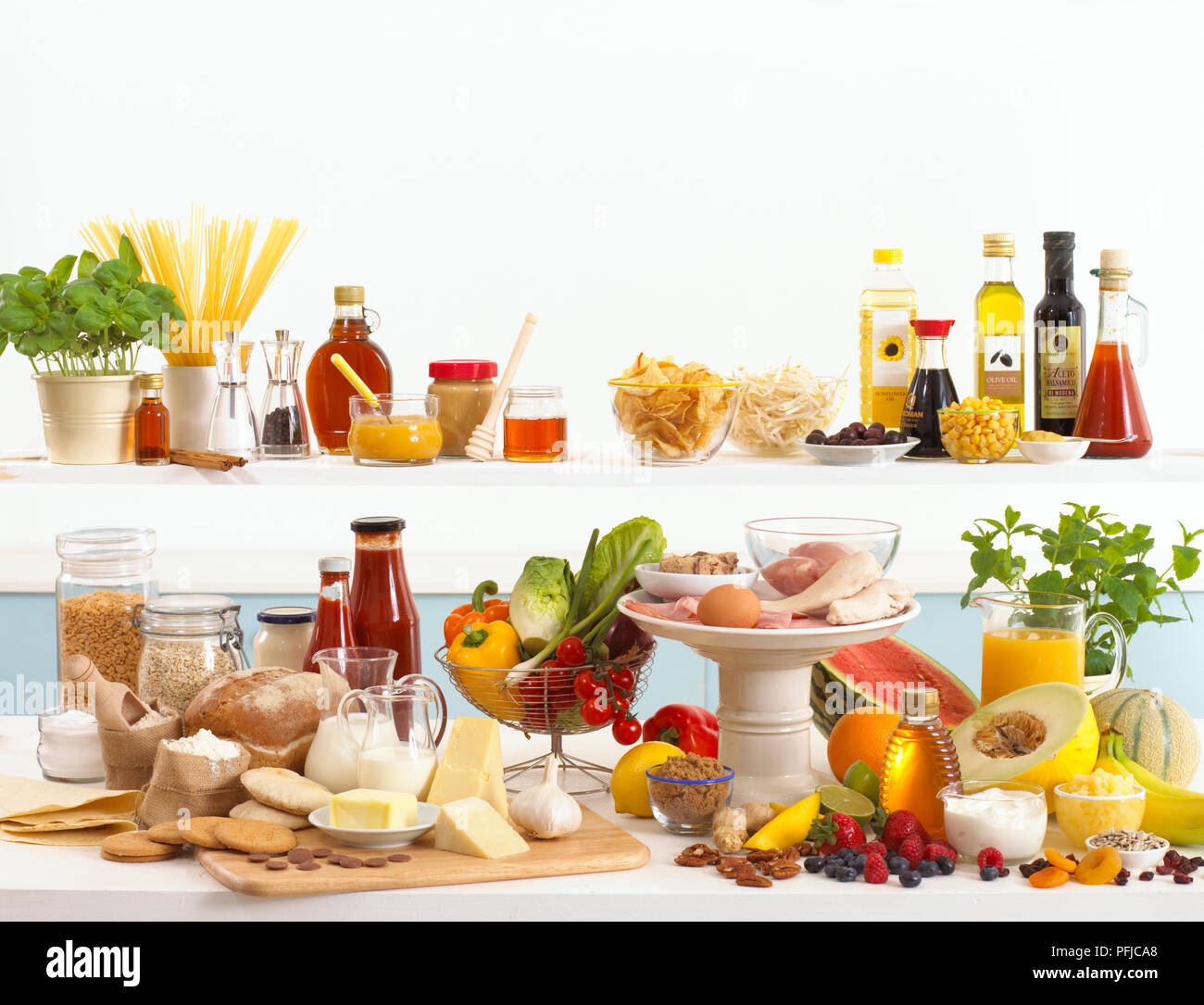 Different types of food and cooking ingredients arranged on two shelves ...