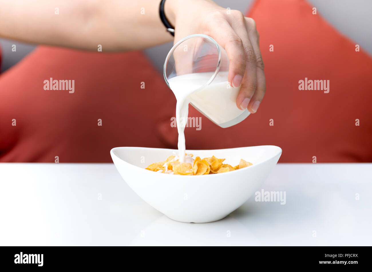 Woman pouring milk on cereal hi-res stock photography and images - Alamy