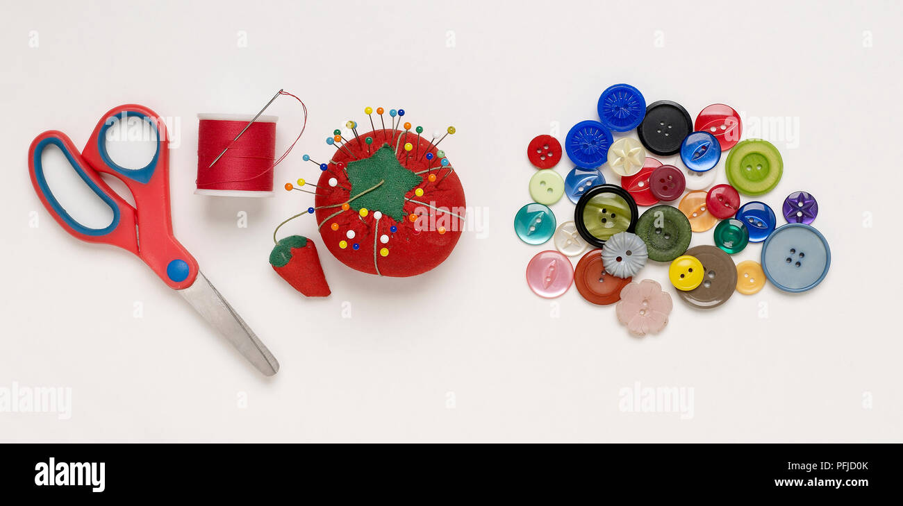 Sewing scissors, needle and thread, pin cushion and buttons Stock Photo ...