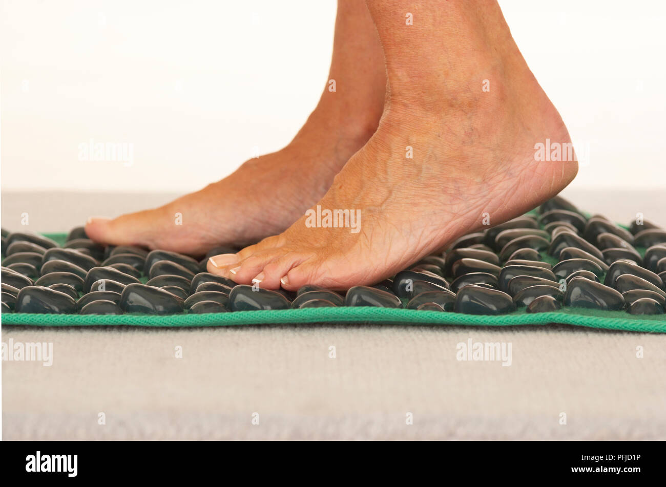 Man walking on cobblestone mat Stock Photo - Alamy