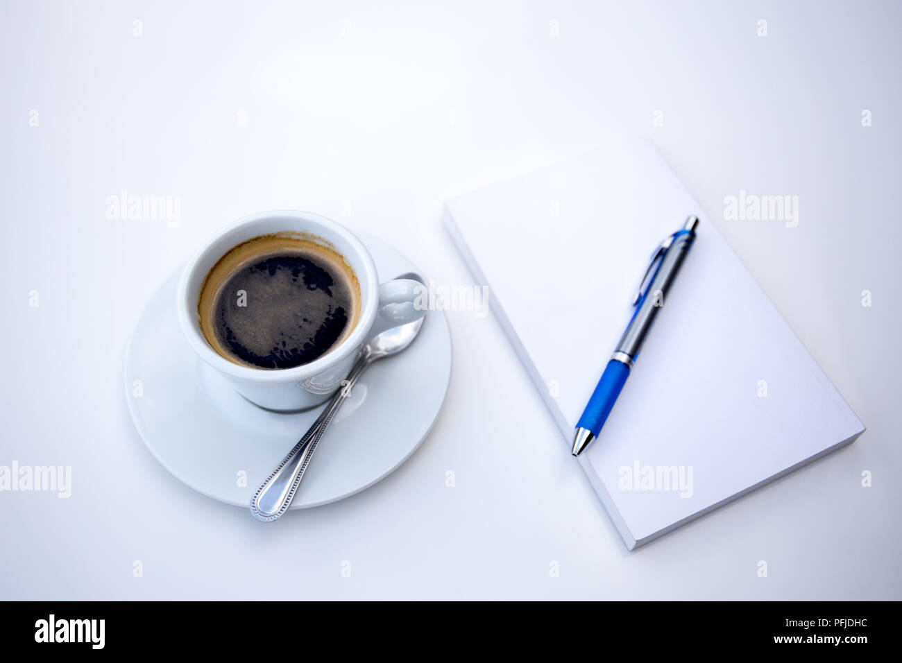 Cup of coffee in morning with pen and note book on white table Stock ...