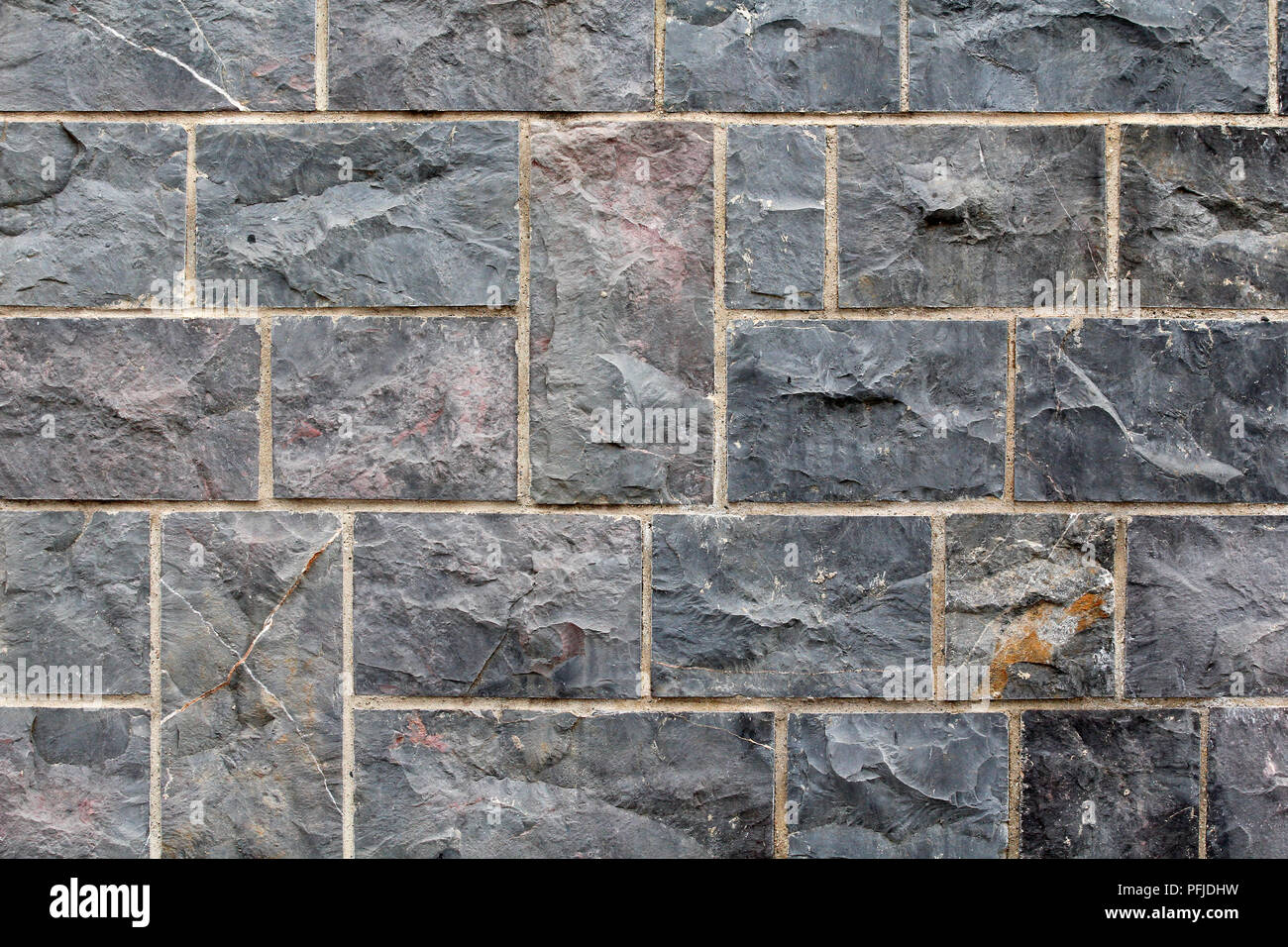 Grey tiled stone wall, construction material Stock Photo - Alamy