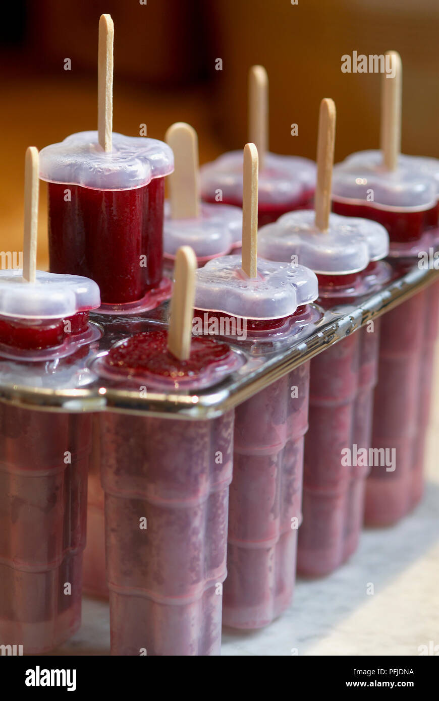Home-made raspberry ice lollies in a rack, close-up Stock Photo - Alamy