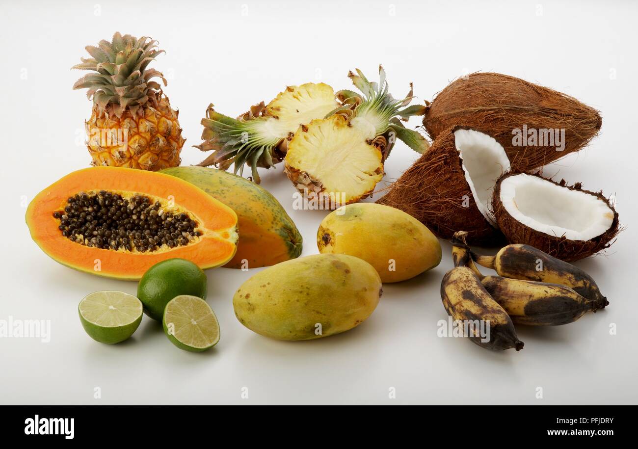 Selection of tropical fruit, including papaya, lime, pineapple, mango ...