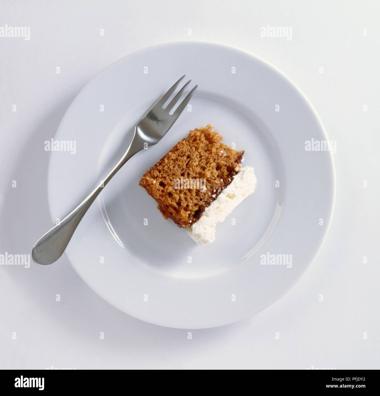 Slice of carrot cake on white plate with fork Stock Photo - Alamy