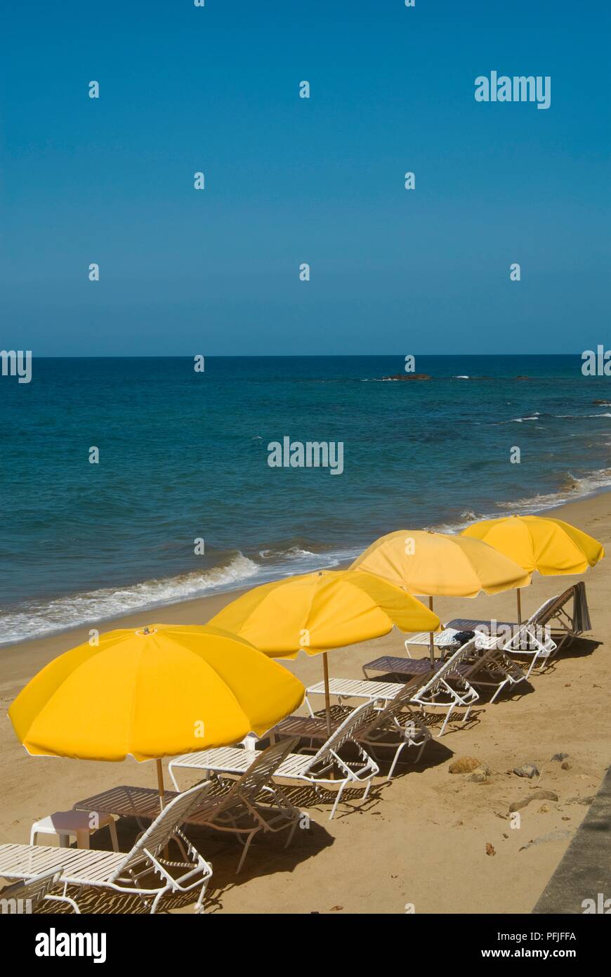 Puerto Rico, Rincon, deckchairs and umbrellas on sandy beach Stock ...