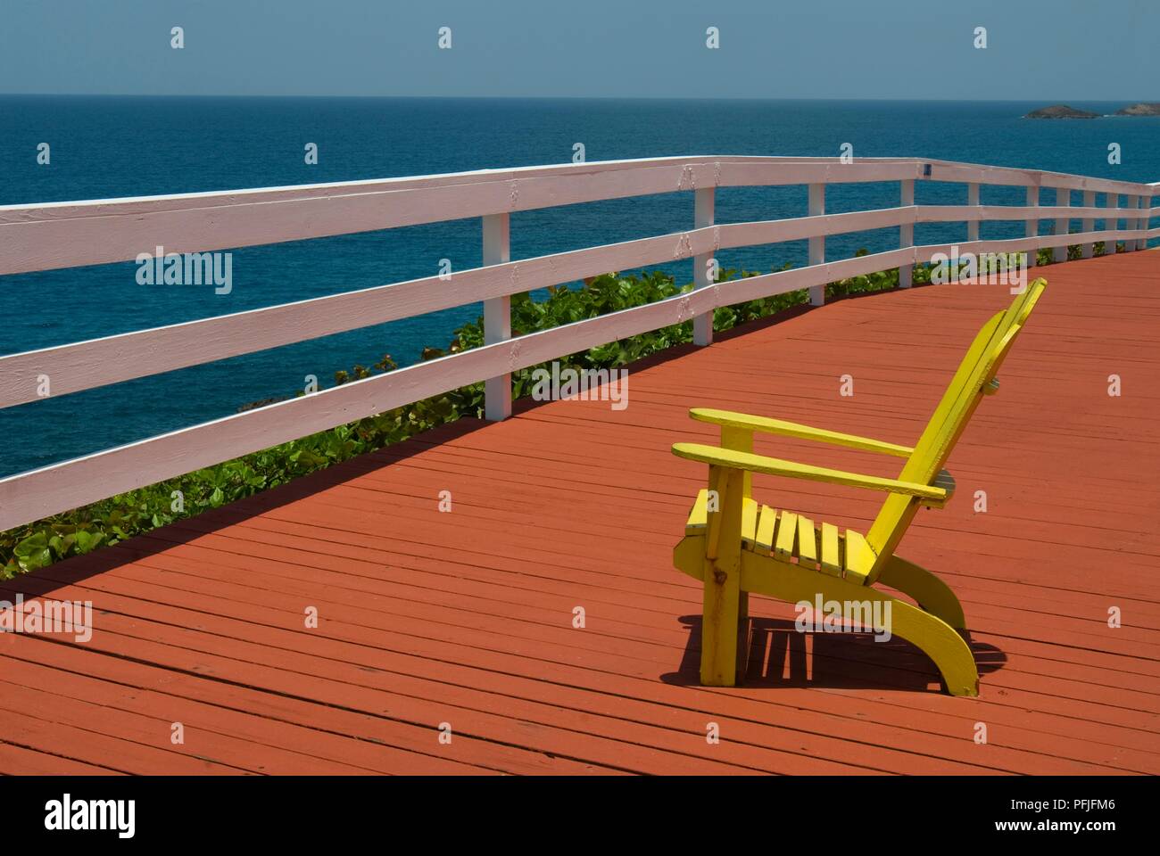 Puerto Rico, Arecibo, empty yellow chair on decking Stock Photo - Alamy