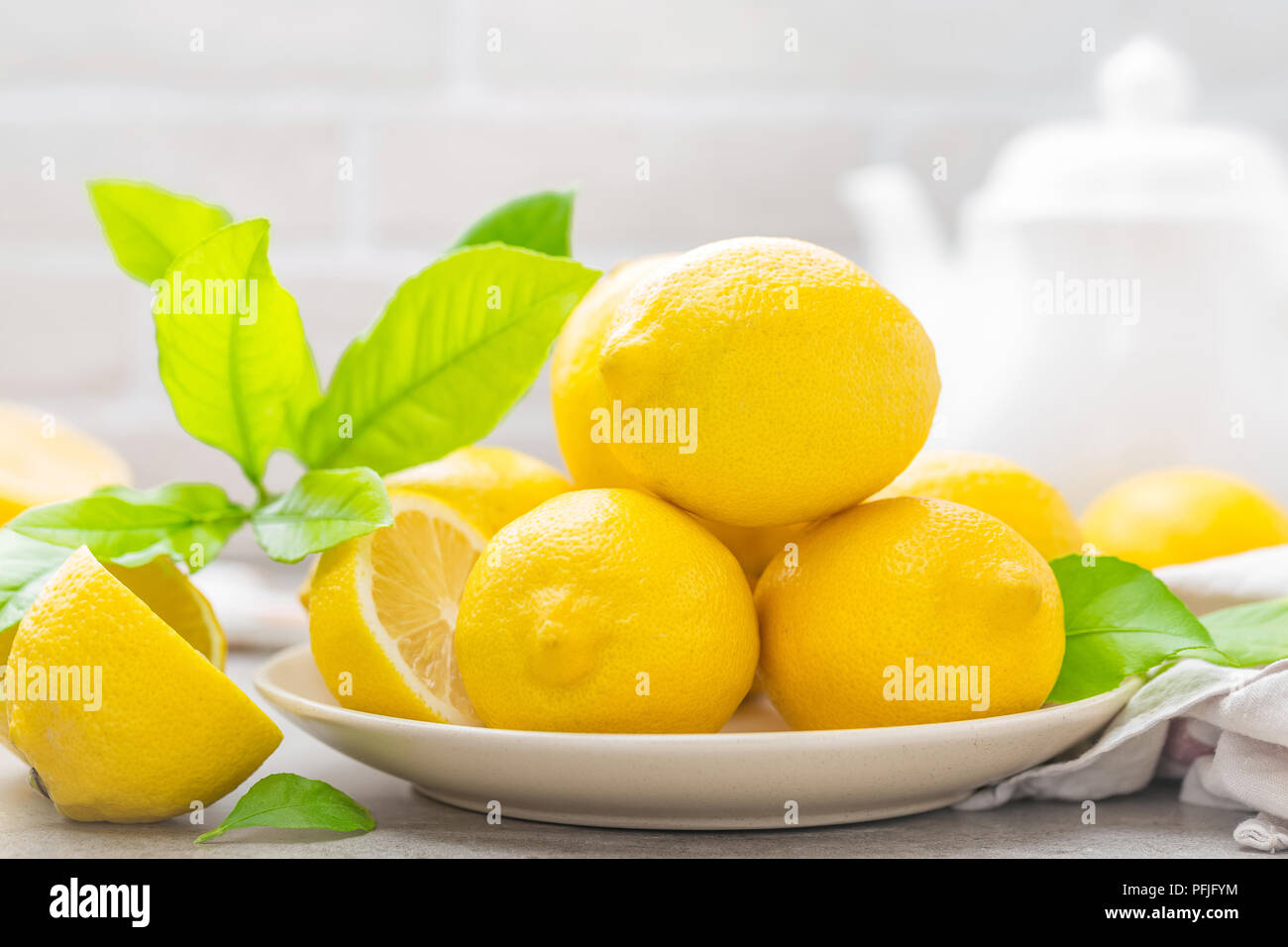 Fresh lemons with lemon leaves Stock Photo - Alamy