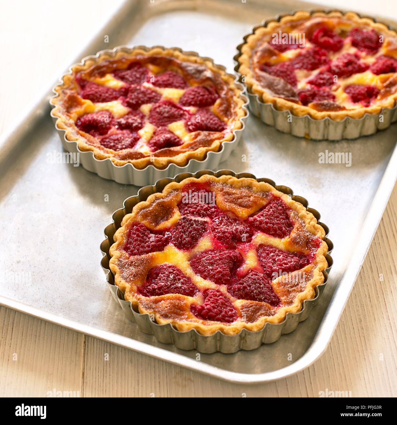 Three raspberry tarts Stock Photo - Alamy