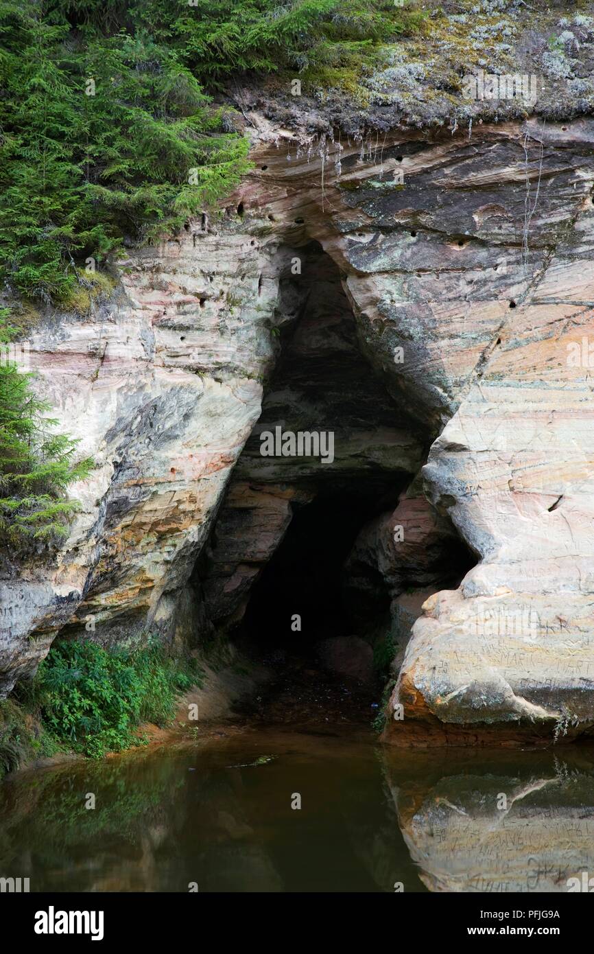 Estonia, Taevaskoja, Neitsikoobas (Maiden's cave) and pond Stock Photo ...
