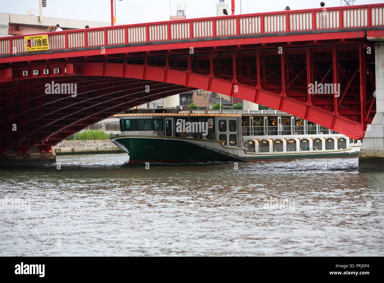 Japan, Tokyo, Koto-ku, Sumida River, boat passing under Azuma Bridge ...