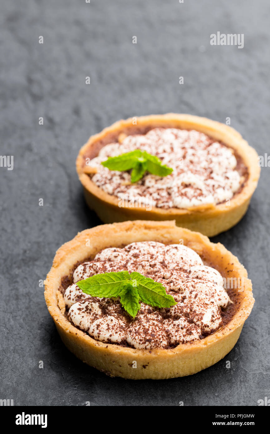 Mini banoffee pie tarts isolated on black stone background Stock Photo ...