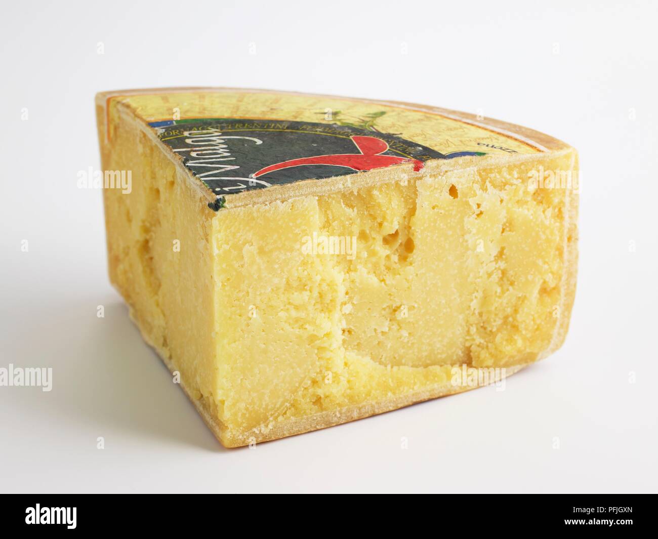 Sliced round of Italian Vezzena cow's milk cheese Stock Photo - Alamy