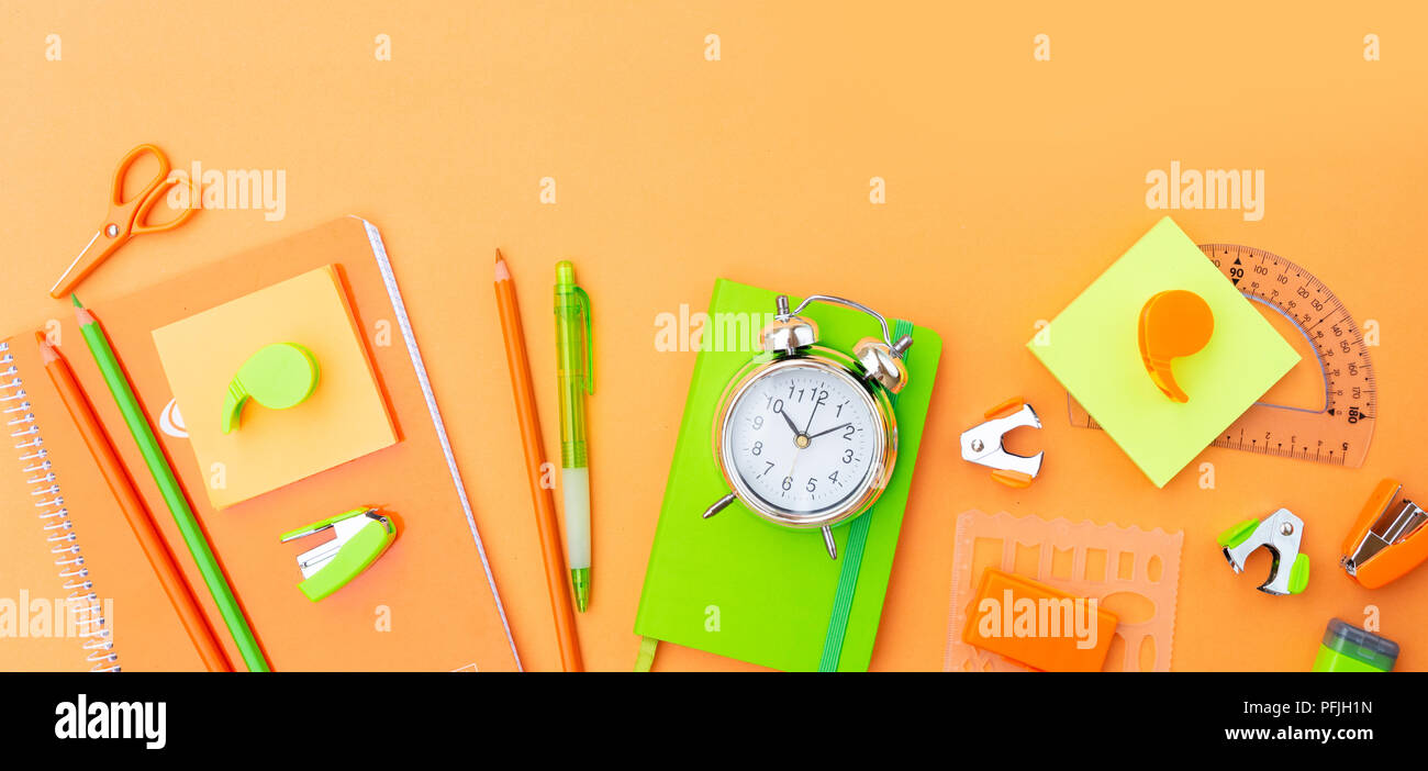 Back to school styled scene with orange and green school supplies on ...