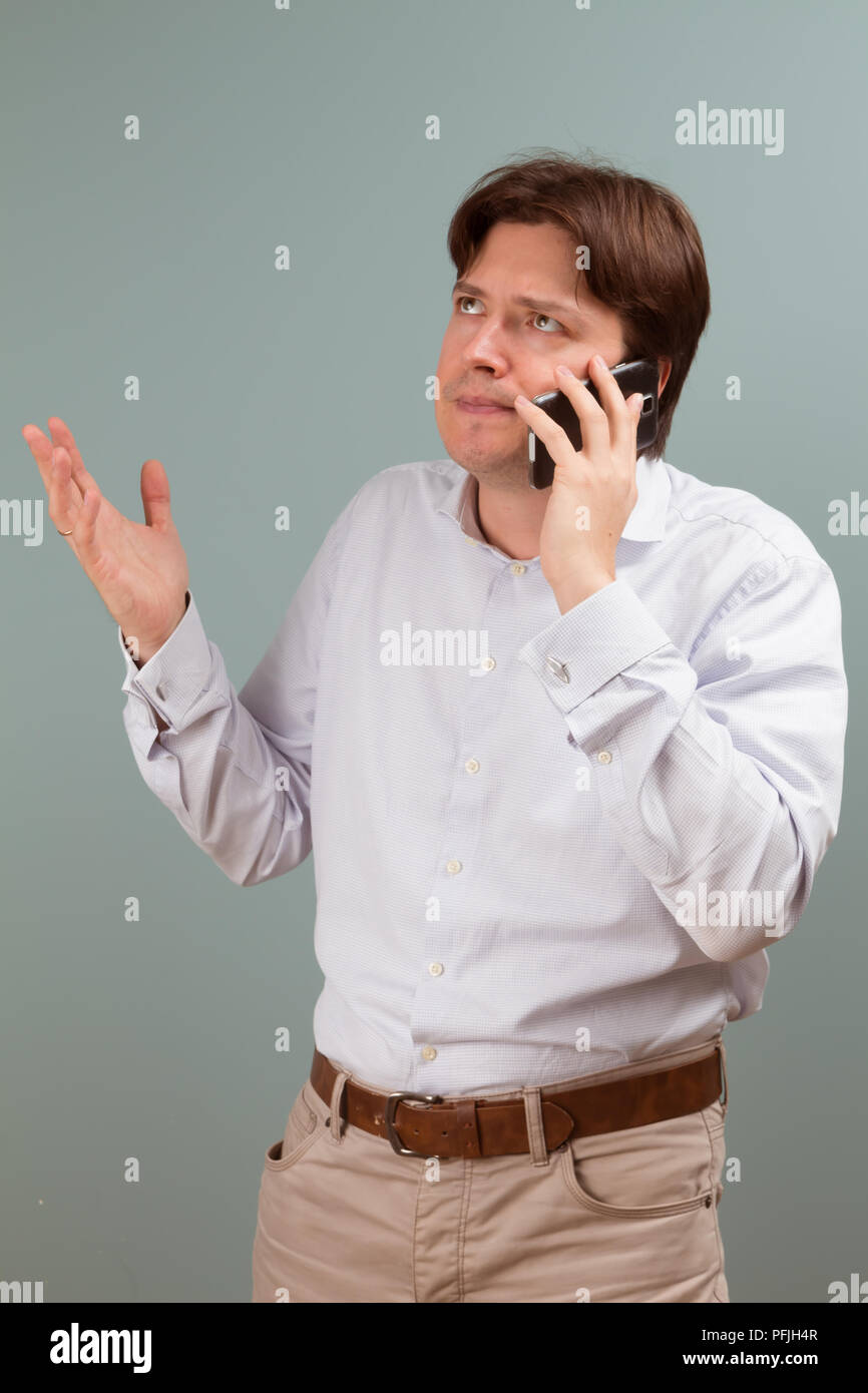 Handsome young man talking over the mobile phone Stock Photo - Alamy