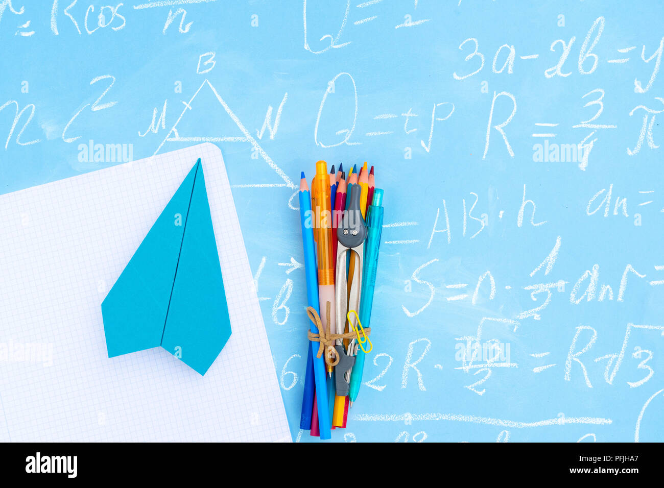 Back to school styled scene with school supplies on blue background ...