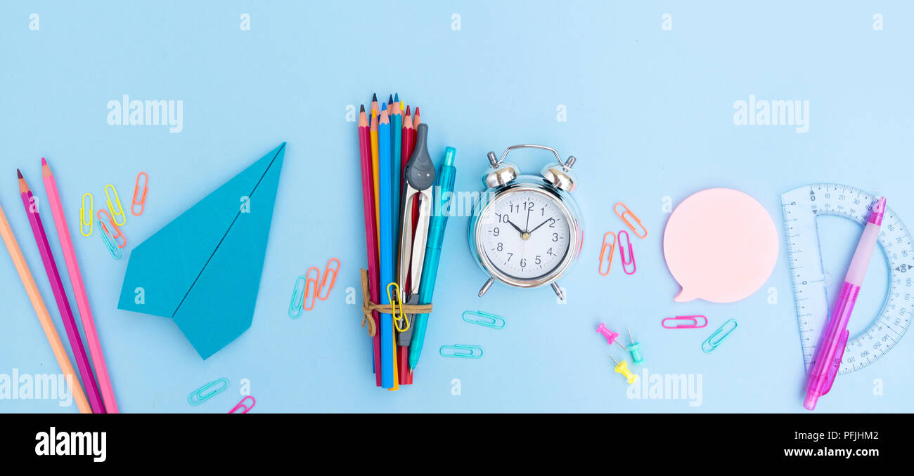 Back to school styled scene with school supplies on blue background ...