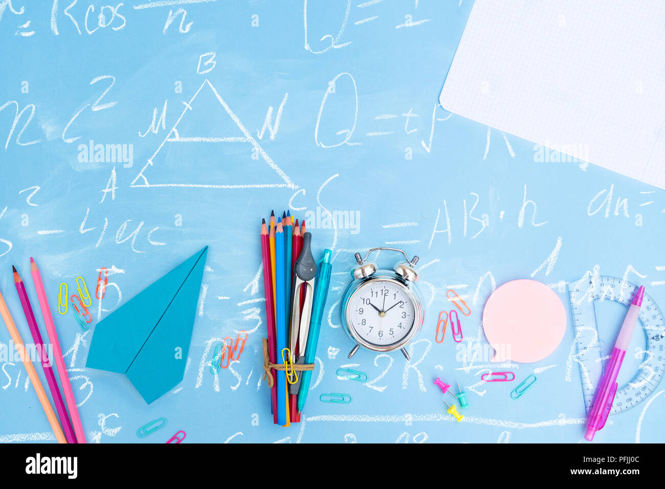 Back to school styled scene with school supplies on blue background ...